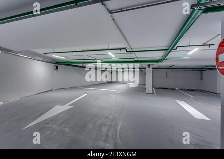 empty underground garage parking with columns and road markings Stock ...