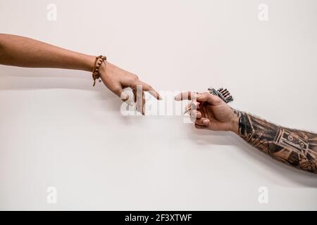 Close up of man hands with tattoo holding fresh juicy burger at cafe ...