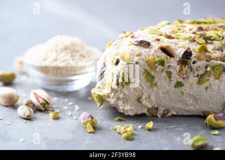 Sesame halva with pistachios on grey background. Top view. Copy space ...
