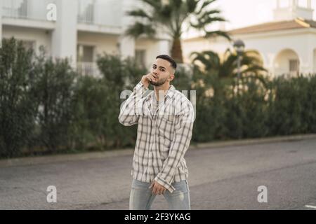 A shallow focus shot of a handsome Spanish Caucasian man with tattoos ...