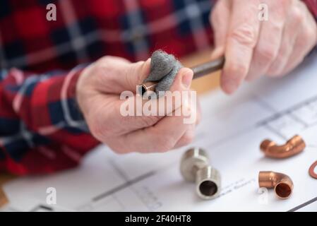Plumber preparing a copper tube before welding; panoramic banner Stock ...