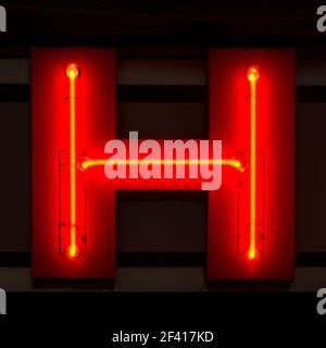 Red glowing neon letter H at night with blue underline Stock Photo - Alamy