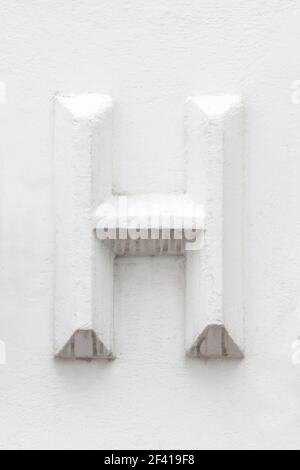 White stucco letter T on white ground Stock Photo - Alamy