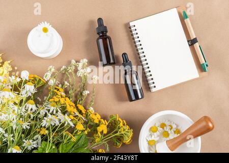 Flat lay of oil, bowl and bouquet of fresh lavender flowers on ...