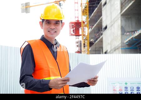 Asian engineer or foreman in front of construction site Stock Photo - Alamy