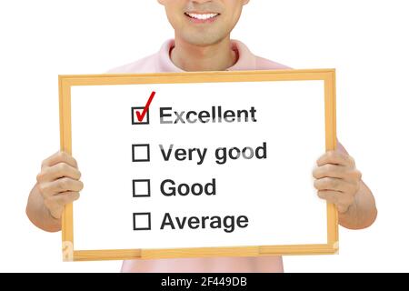 Tick mark in front of Excellent word on blackboard held by smiling man ...