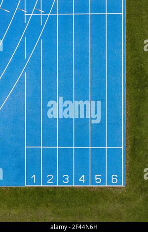 Aerial view of a stadium with a blue running track, surrounded by ...