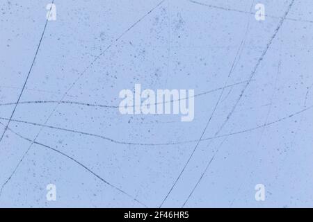 Scratched blue plastic texture background. With holes caused by flames ...