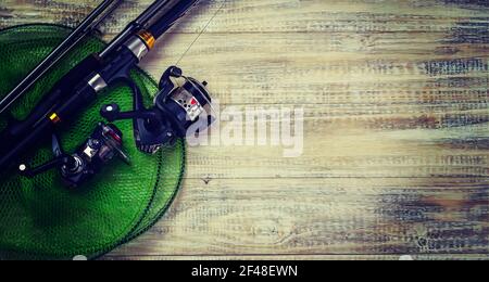 Fishing tackle, many colorful baits with a fishing rod on a wooden pier ...