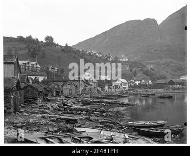 Merok. Beach with rowing boats. View over wooden huts, Hotel Geiranger ...