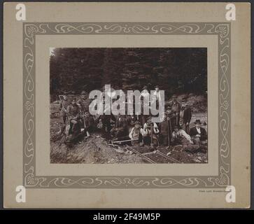Group portrait of track farmers and military members Stock Photo - Alamy