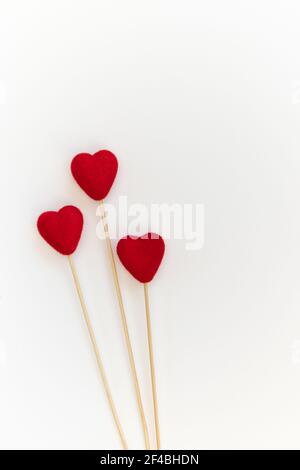 Red textile hearts on wooden sticks closeup. Valentines day background ...