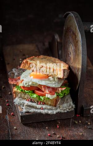 Homemade British Bacon Sandwich on a rustic wooden board, side view ...