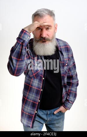 Portrait of a mature bearded man gesturing with his hand while asking a ...