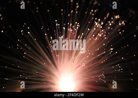 A closeup shot of a color-changing fibre optic lamp in the darkness ...