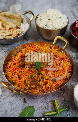 Assorted Indian ethnic food buffet on rustic concrete table from above ...