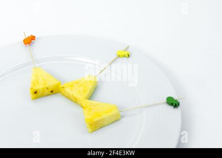 Pineapple skewers peeled and cut into triangles with chopsticks ...