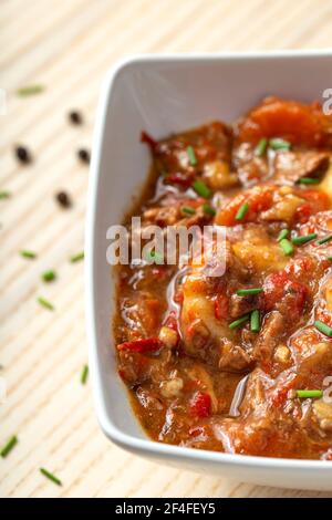Delicious potato dumplings with stewed red cabbage close-up on a plate ...