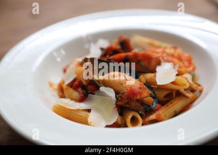 Penne pasta tomato sauce arabiata with seafood on wood background ...