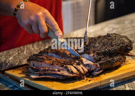 slicing a beef brisket fresh off of the smoker Stock Photo - Alamy