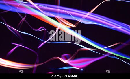 Colorful fiber strings in motion against black background Stock Photo ...
