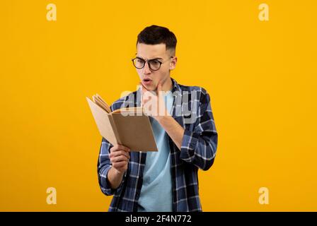 Young Caucasian student having difficulty understanding textbook ...