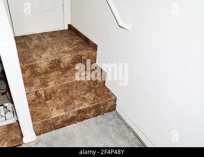 New tile installation on steps with a landing in preparation to be ...
