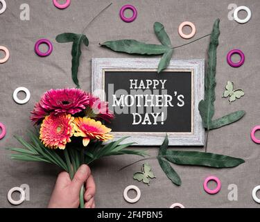 Picture with text HAPPY MOTHER'S DAY and pencils on pink background ...