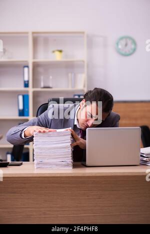 Young employee extremely tired with excessive work Stock Photo - Alamy