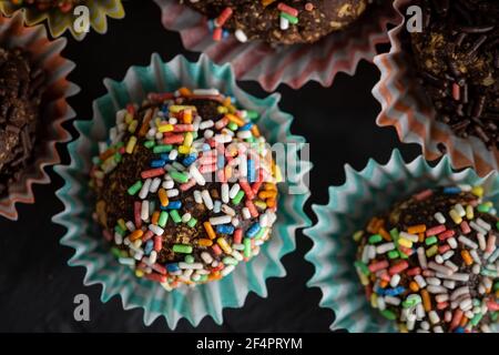 Closeup shot of rainbow sprinkle munchkins on paper muffin cups Stock ...