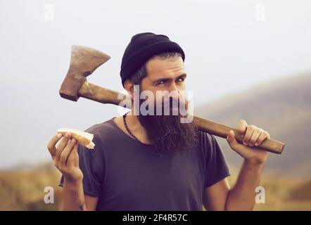 brutal bearded man lumberjack hold axe outdoor. bearded man lumberjack ...