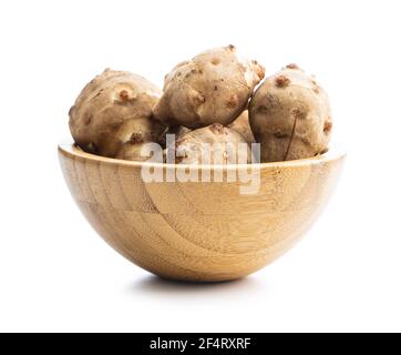 Raw jerusalem artichoke in wooden bowl. Topinambur vegetable root ...