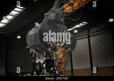 Mechanical grabber at work in a recycling plant in England Stock Photo ...