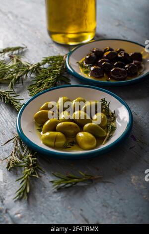 Green olives on branch with blue sky background Stock Photo - Alamy