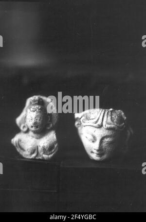 China. Dandan-Oilik (?). Plaster stucco heads. Devi and Apsara (right ...