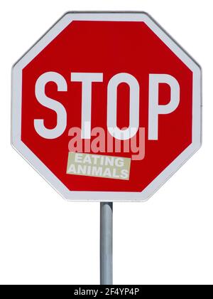 Road sign, Stop sign with sticker „eating animals“, sky with dark ...