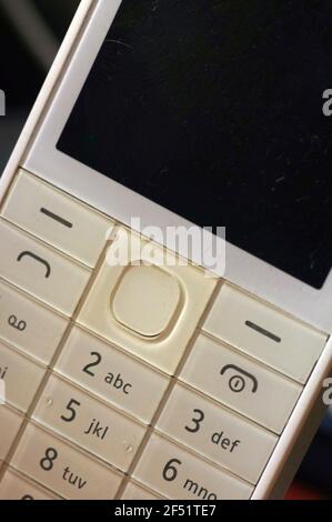 White phone keyboard - old generation. Bright white key with numbers ...