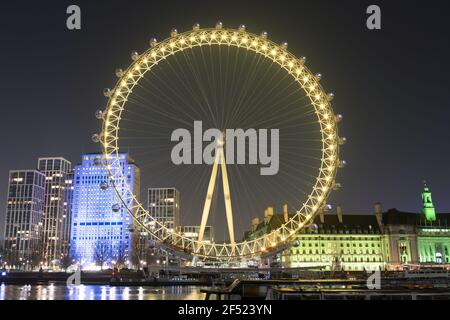 23rd March 2021, national reflection day when London eye yellow lights ...