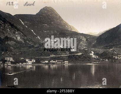 Merok. City with majestic mountains. View of the bay with houses from ...