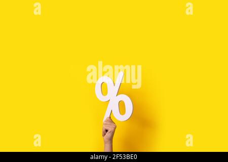 percentage sign in hand over yellow background, panoramic image Stock ...