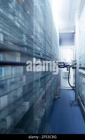 Modern pharmacy storage room and robot hand s are arranging and storing ...