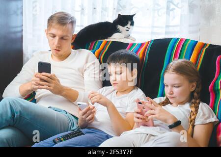 Happy alone dad looking at phone screen with children kids. smiling ...