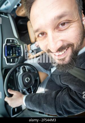 Funny wide angle of a male driver in luxury car Stock Photo - Alamy