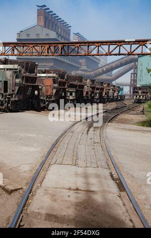 Metallurgical plant. Slag cars train on track. Blue sky background ...