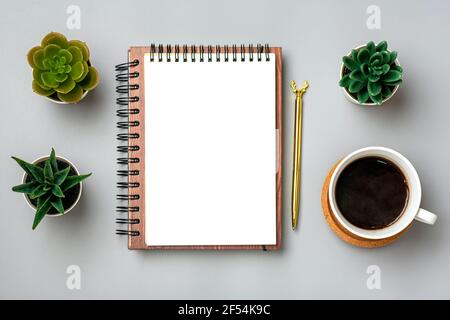 open notepad, cup of coffee, golden pen on gray background, spiral ...