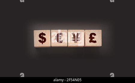Dillar, euro, yen and pound on building blocks. wooden cubes with ...