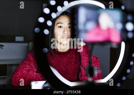 Female influencer vlogging in clothing boutique Stock Photo - Alamy