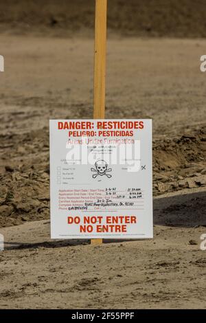 A sign warning of the application of pesticide fumigant on what was an ...