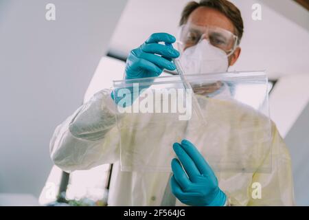 Medical worker taking swab for corona virus sample from potentially ...