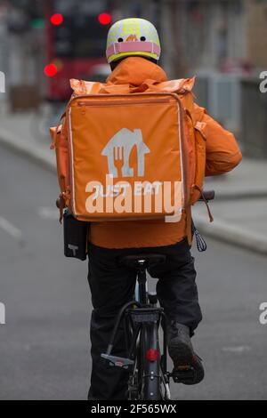 London - Just Eat delivery cyclist riding in cycle lane. Credit: Sinai ...